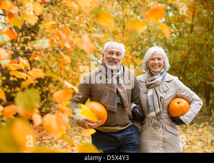 Senior man with pumpkins in autumn forest Stock Photo - Alamy