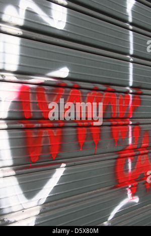www painted on shop door shutters in rome italy Stock Photo - Alamy