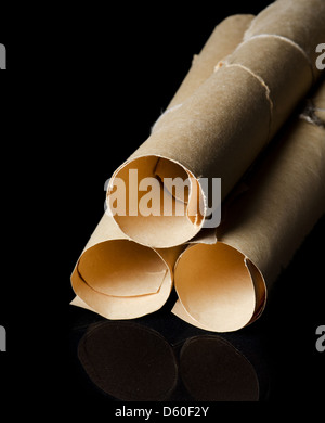 Old parchment scrolls on black background, space for design ...