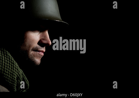 Portrait in profile of a WW2 U.S. soldier against a black background ...