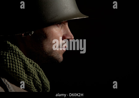 Portrait in profile of a WW2 U.S. soldier against a black background ...
