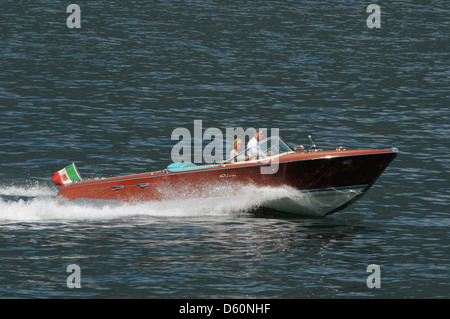 Classic wooden power boat Riva Tritone passing Poncelet with high speed ...