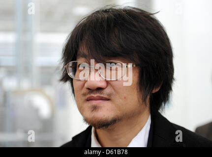 Documenta artist Yan Lei stands in front of his paintings at the ...