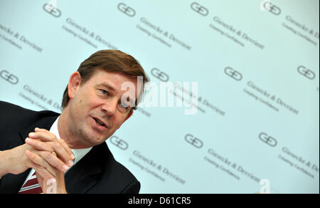 Giesecke & Devrient CEO Karsten Ottenberg poses in front of the company ...
