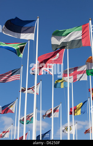 Flags of many nations flutter in the wind in front of the camp entrance ...