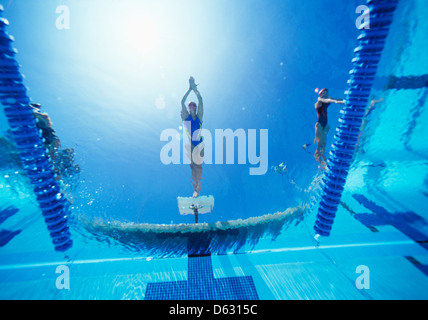 young woman diving into swimming pool Stock Photo - Alamy