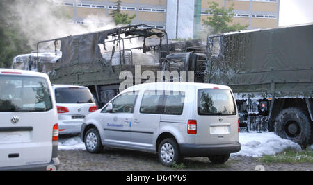 Burned out German Armed Forces (Bundeswehr) vehichles sit on a ...