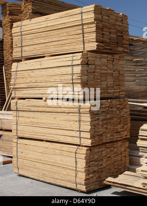 Stack of new wooden studs at the lumber yard. Wood timber construction ...