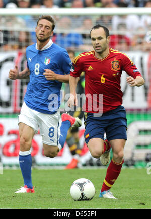 Spain's Andres Iniesta (L) and Italy's Claudio Marchisio vie for the ...