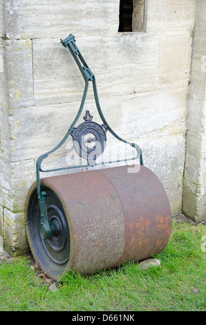 Old lawn roller with rusty metal drum / roller and green painted handle ...