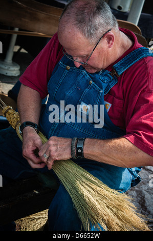 Craftsman assembling handmade brooms Stock Photo - Alamy