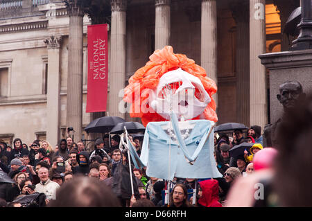 London, UK. 13 April 2013. A woman wearing a Margaret Thatcher mask ...