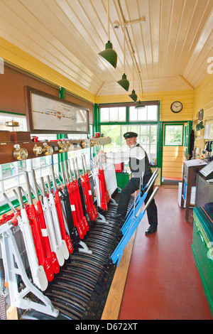 Signalman Geoff Truscott at work in the signal box at Corfe Castle ...