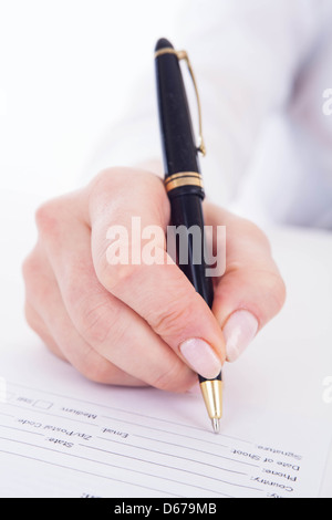 Hand filling out the form on white Stock Photo - Alamy