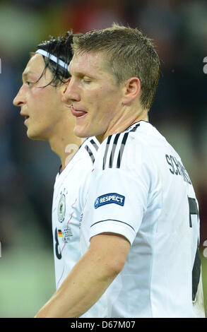 Germany's Bastian Schweinsteiger (L) and Mesut Oezil react during the ...