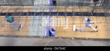 Texas Rangers pitchers warm up during spring training baseball workouts ...