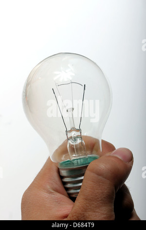 plain light bulb in human hand Stock Photo - Alamy