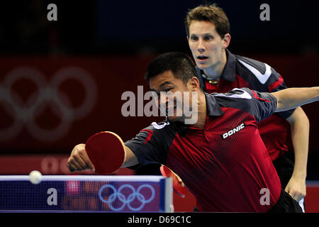 Austria's Chen Weixing (front) in action against Germany's Boll and ...