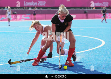 Jennifer Plass (L) of Germany fights for the ball against Clarissa ...