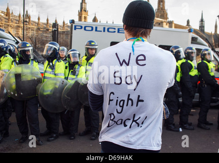A protestor stands in-front of Metropolitan Police riot officers. The ...