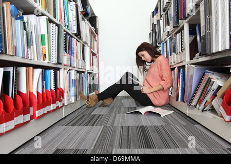 Student reading in library Stock Photo - Alamy