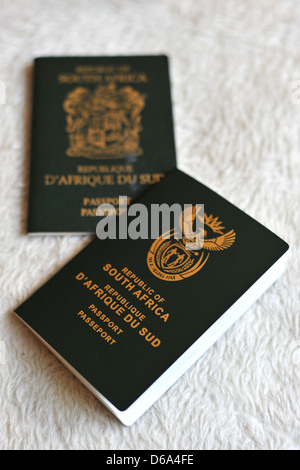 An example of an old South African passport next to a new South African ...