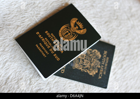 An example of an old South African passport next to a new South African ...