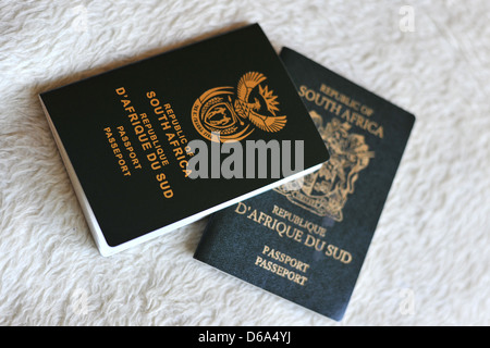 An example of an old South African passport next to a new South African ...