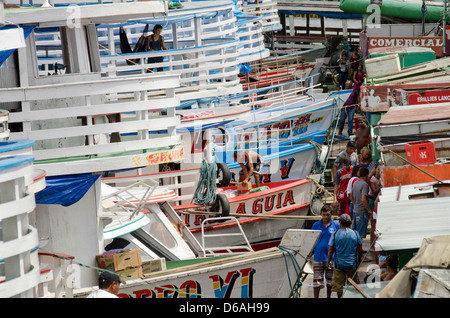 Brazil, Amazon, Manaus. Busy waterfront pier. Local workers bathing in ...