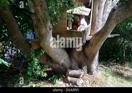 Girl climbing in treehouse outdoors Stock Photo: 72118713 - Alamy