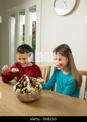 Teenager girl holding ice cream looking away to side with smile on face ...