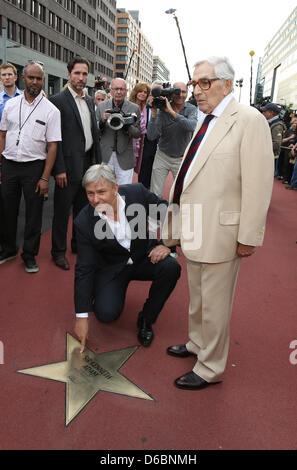 Scenographer Sir Kenneth Adam (R) and mayor Klaus Wowereit (L) present ...