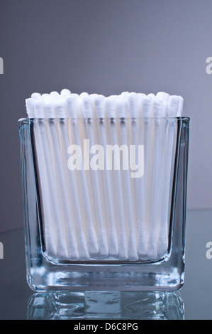 Cotton buds in a glass close up grey background Stock Photo - Alamy