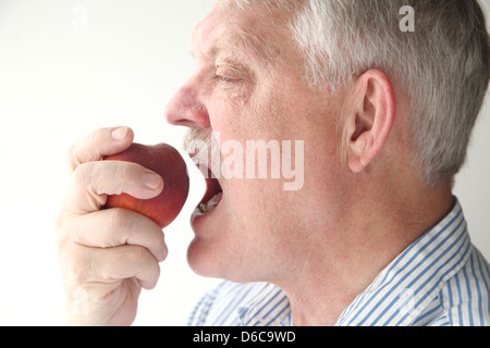Senior man ready to bite into a peach Stock Photo - Alamy