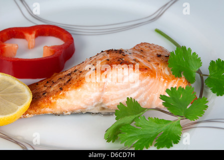 Slice of red fish salmon with lemon, rosemary and peppercorns isolated ...