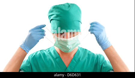 Pulling on surgical mask Stock Photo - Alamy