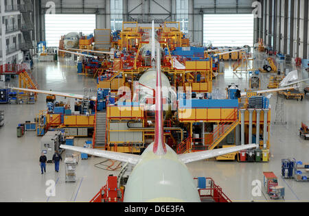 Skilled personnel work on aircraft at the A320 final assembly hangar at ...