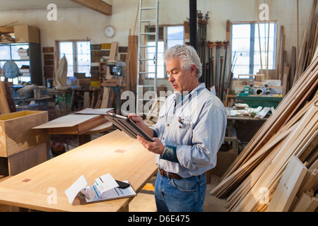 Serious mature hispanic man man checking home finance calculating money ...