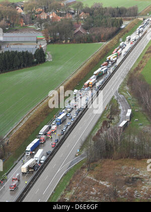 Wrecked cars and trucks sit at the front of a multiple vehichle ...