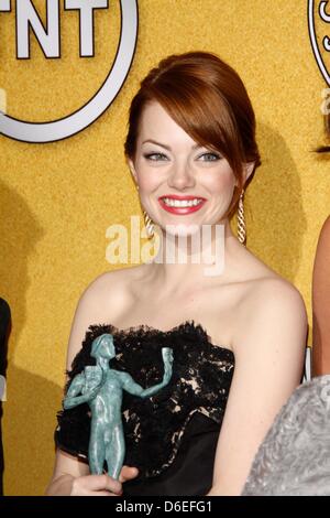 Emma Stone poses in the press room with the award for best performance ...