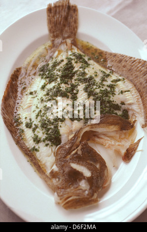 Cooked Whole Turbot fish in baking pan oven with potatoes, bell pepper ...