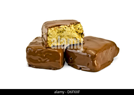 Two whole and one half of halva glazed with chocolate isolated on white ...