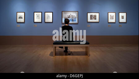 A staff member views works of the Swiss artist Adrian Zingg Stock Photo ...