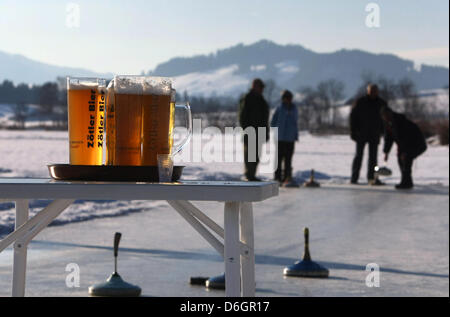 Beer sits ready for a group of ice stick throwers on the frozen ...