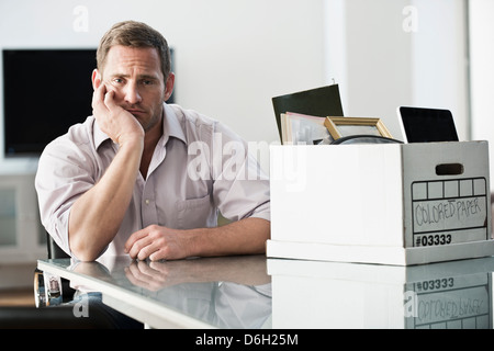 Businessman packing up box in office Stock Photo - Alamy