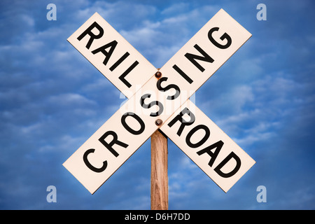 railroad crossing sign under blue sky in the USA Stock Photo - Alamy