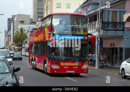 Red bus of City Sightseeing Cape Town and the skyline of Cape Town ...