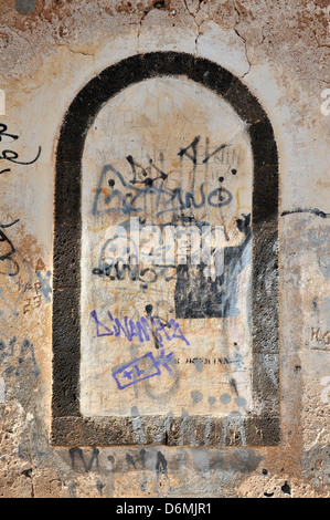 Graffiti sprayed on an old wall in Newquay town centre in Cornwall in ...