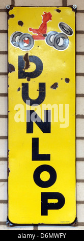 A Dunlop enamel advertising sign displayed at the Den Hartog Ford ...