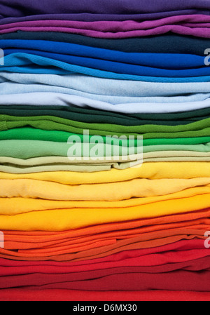 Rainbow clothes background. Pile of bright folded clothes Stock Photo ...